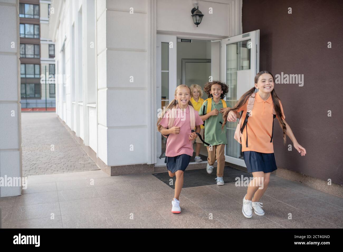 Kids running out of school hi-res stock photography and images - Alamy