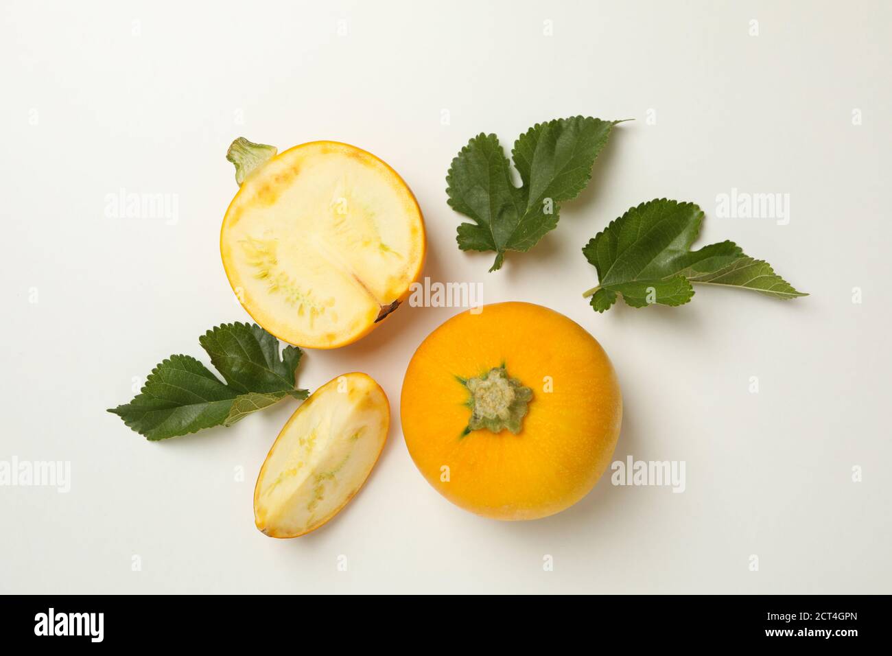 Round zucchini and leaves on white background Stock Photo - Alamy