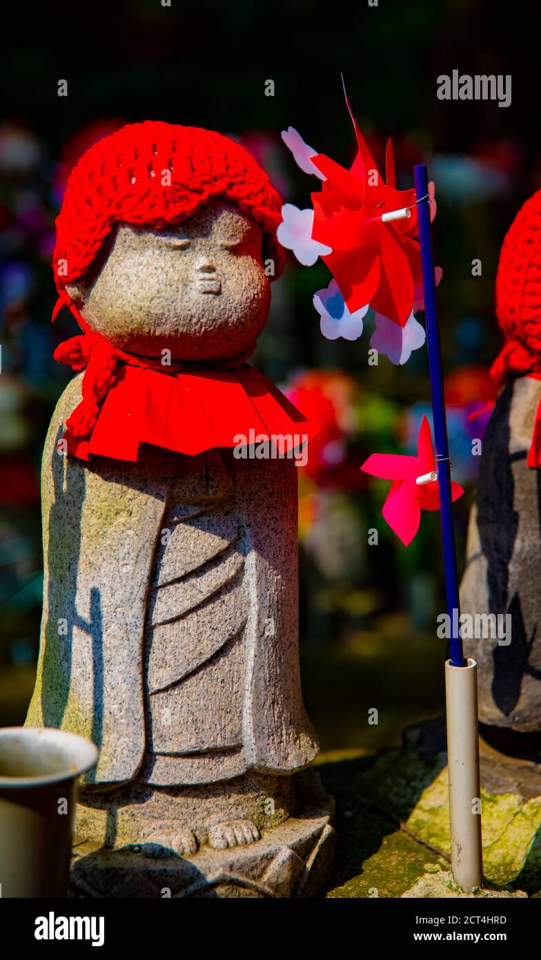 Statue guardian wearing red hat in Tokyo daytime Stock Photo - Alamy