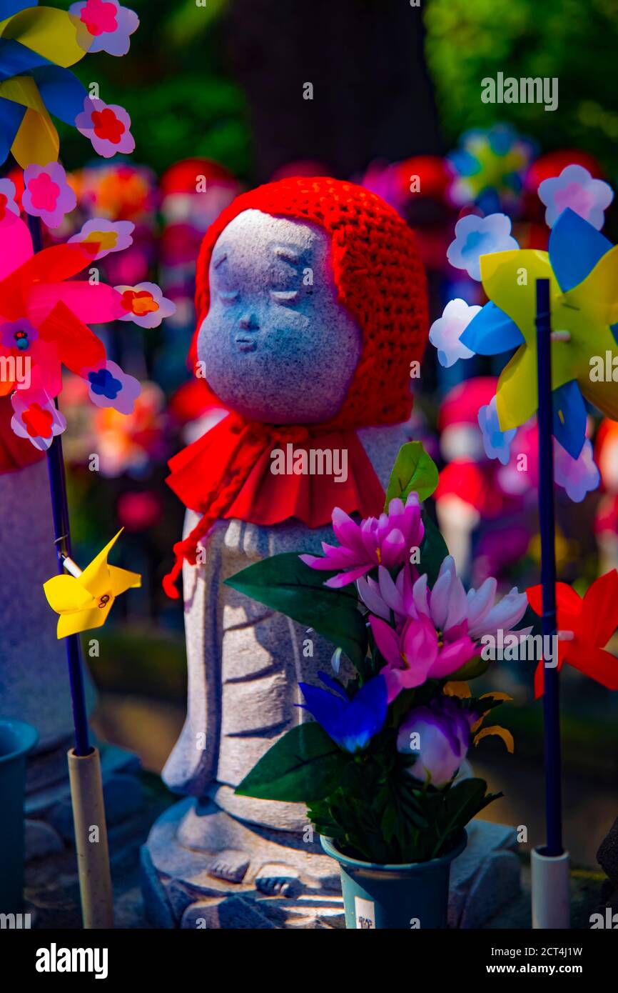 Statue guardian wearing red hat in Tokyo daytime Stock Photo - Alamy