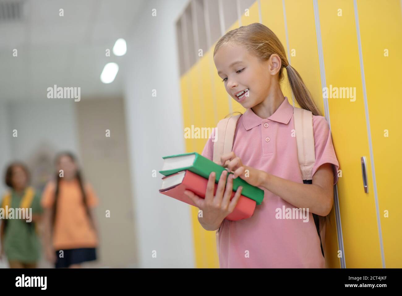 Pretty girl standing near the lockers in school corridor Stock Photo ...