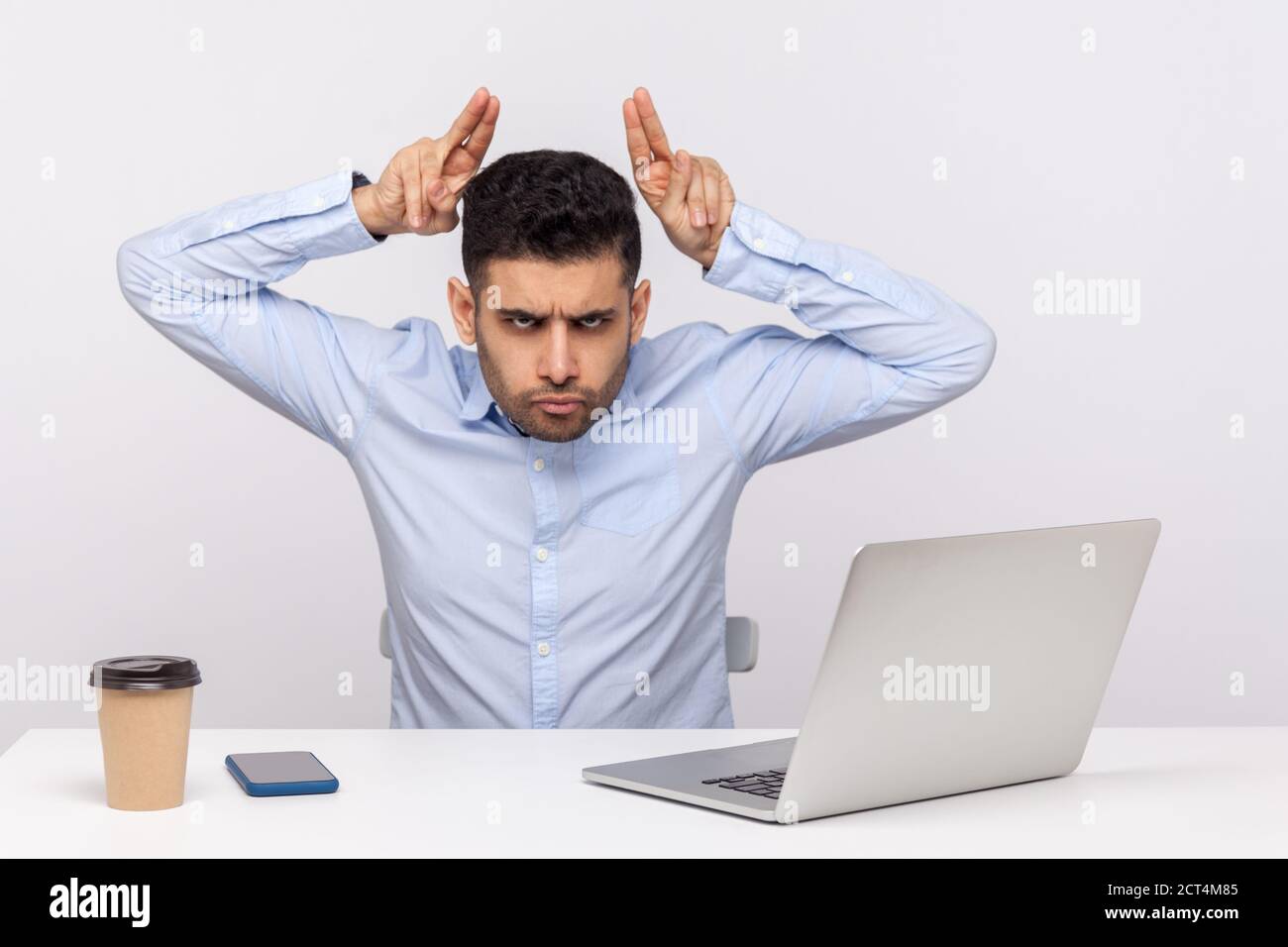 Conflict at work. Aggressive man employee sitting office workplace and ...