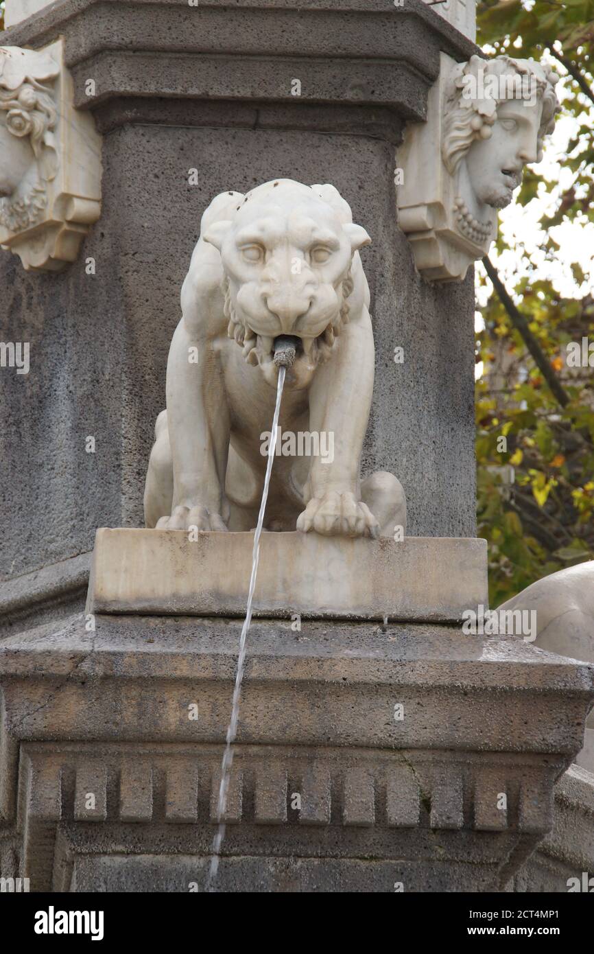 Vertical shot of a statue of a lion spitting water in a park Stock ...