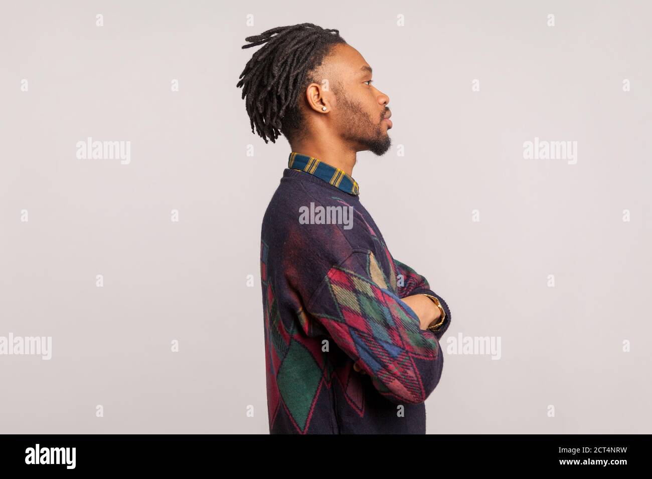 Side view serious concentrated african man with dreadlocks and beard ...
