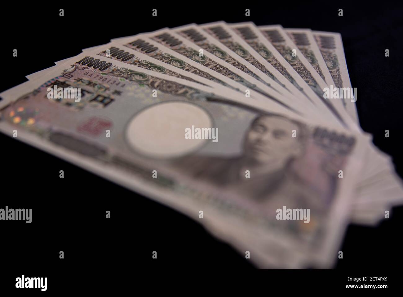 Japanese currency 100,000 yen on the black background Stock Photo - Alamy