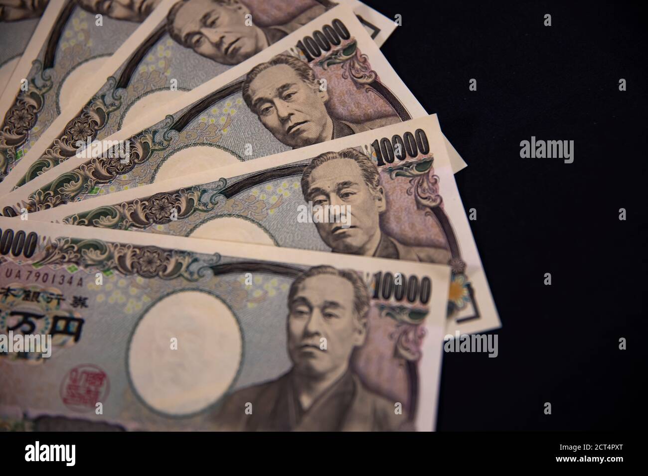 Japanese currency 100,000 yen on the black background closeup Stock ...