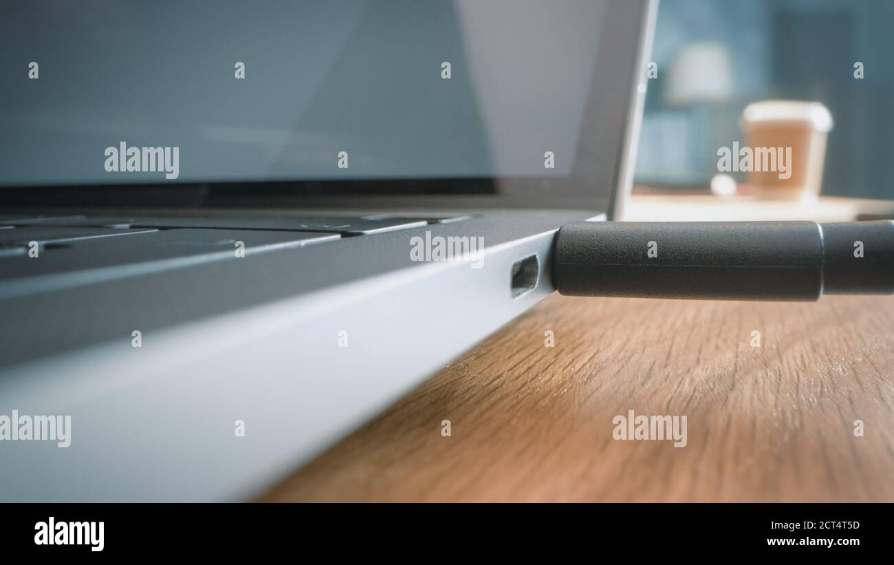 Close-up Macro Shot: Laptop on the Desk, Person Inserts USB-C Cable ...