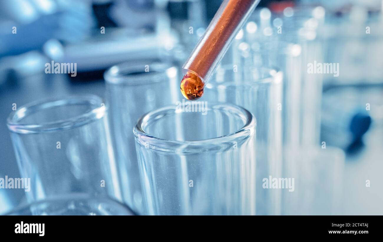 Pharmaceutics Laboratory: Pipette Dropping Red Orange Liquid into Test ...