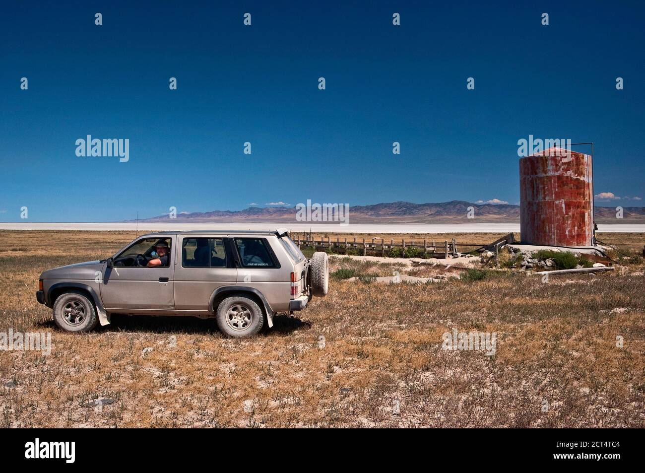 Traveler, 4WD vehicle, at abandoned water tower at Sevier Lake, dry ...