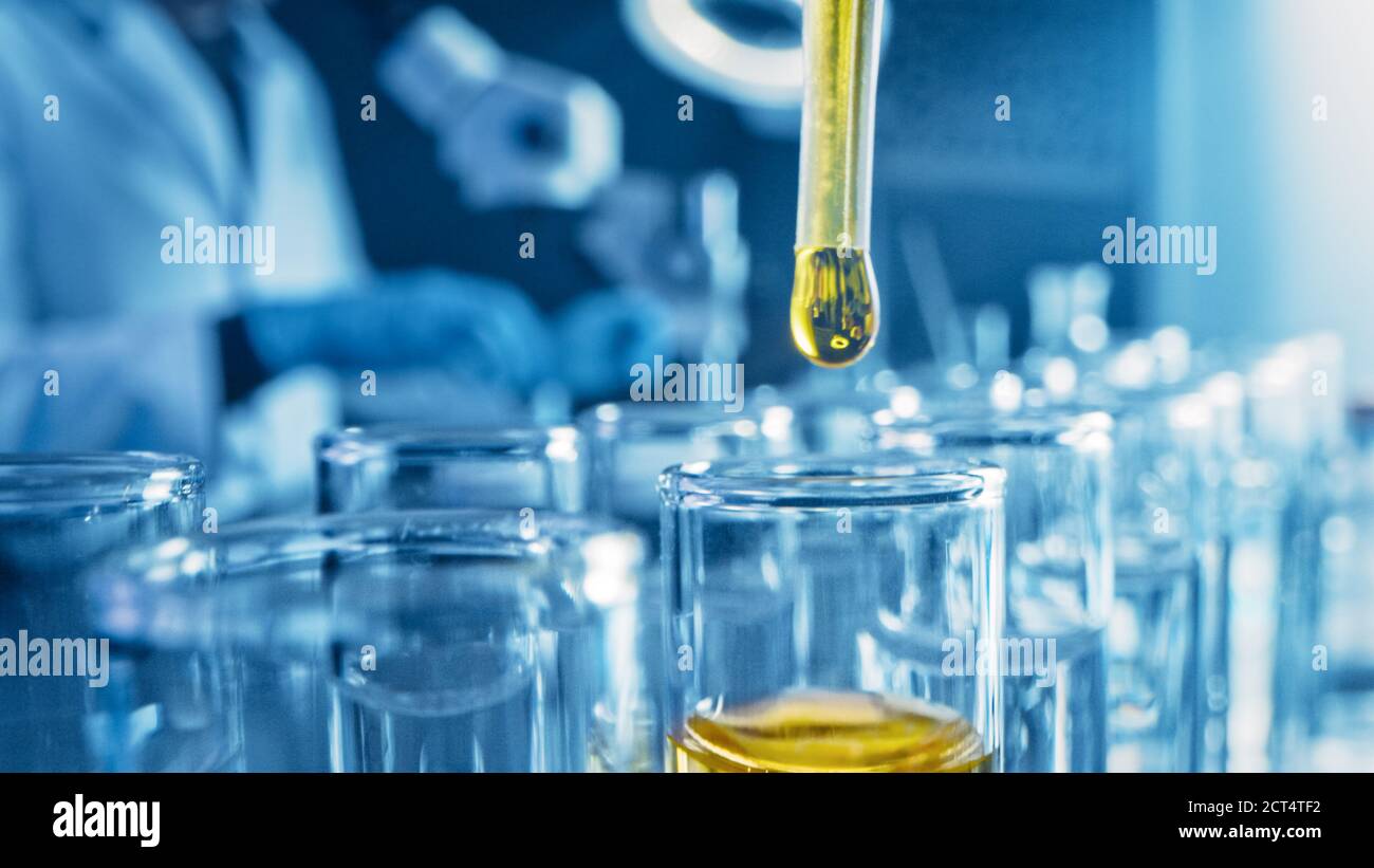 Pharmaceutics Laboratory: Pipette Dropping Yellow Liquid into Test ...