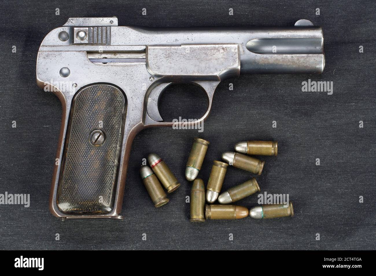 Old rusty handgun with ammunition on black background Stock Photo - Alamy