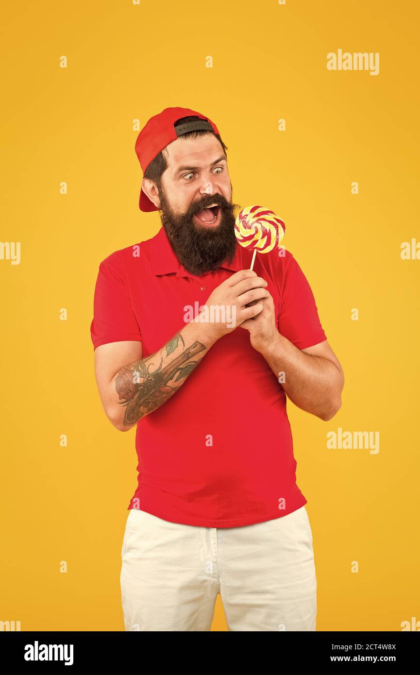Who cares about diet. Bearded man with lollipop. candy shop assistant ...