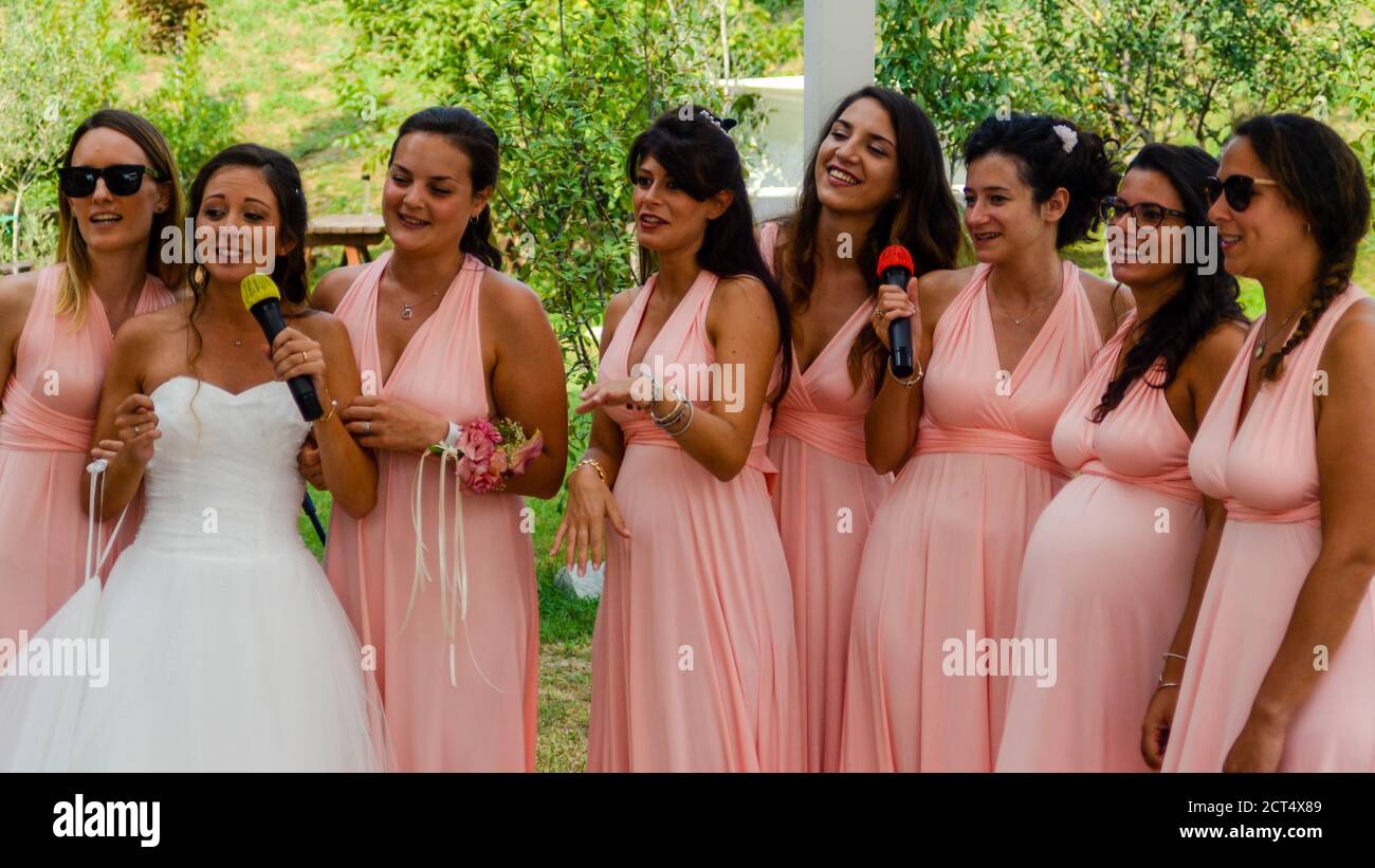 Bride and bridemaids singing in the party celebration after ceremony ...