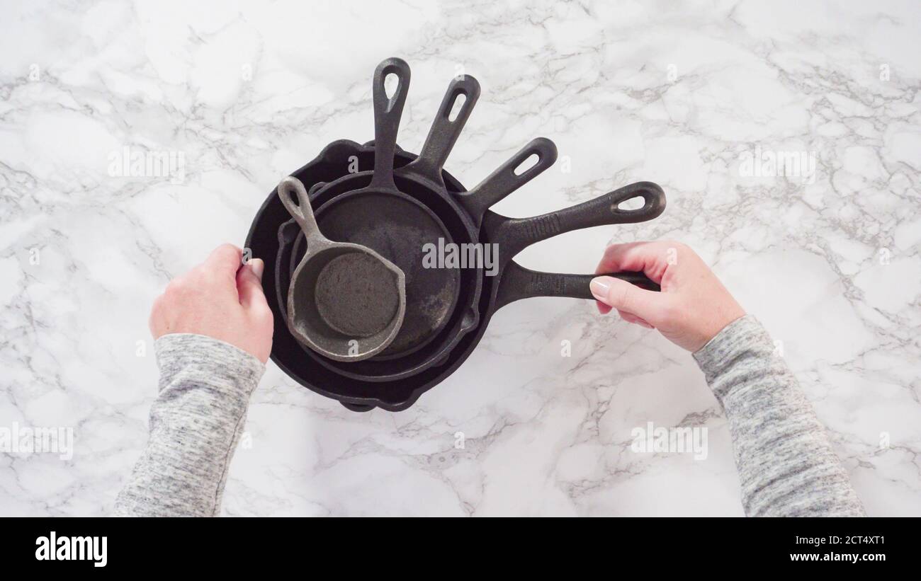 Flat lay. Variety of cast iron kitchenware on a marble countertop Stock ...
