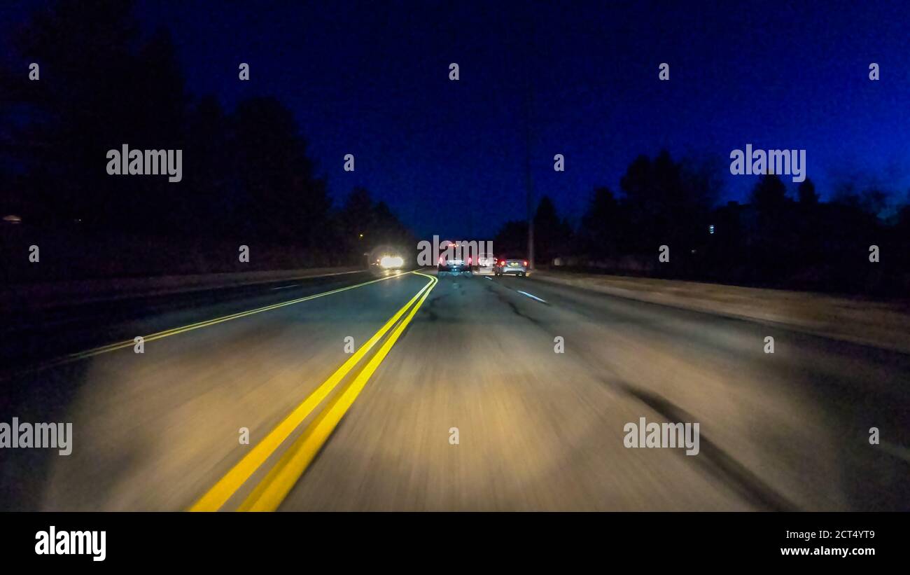 Driving on typical paved roads at night in suburban America Stock Photo ...
