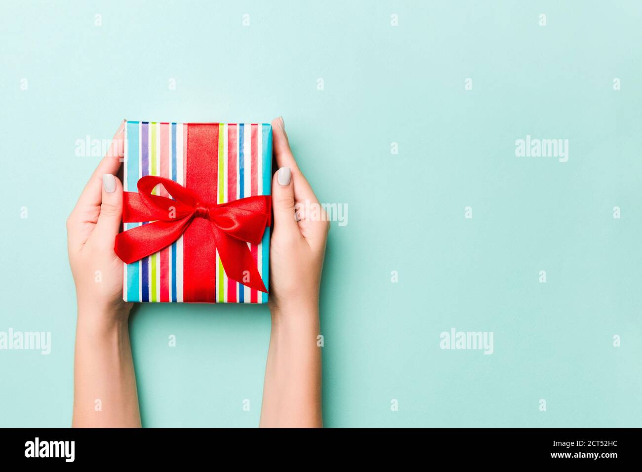 Woman hands give wrapped christmas or other holiday handmade present in ...