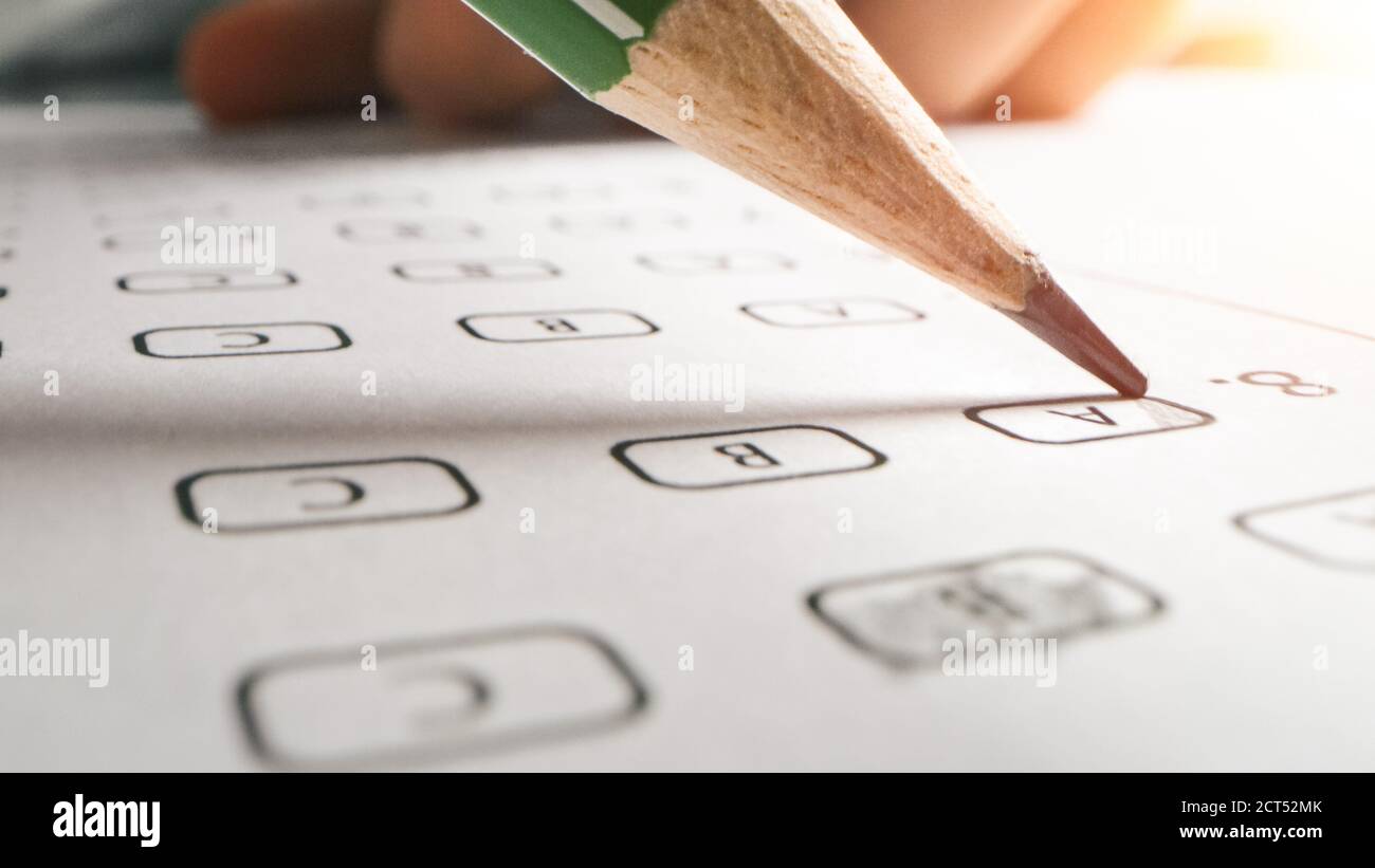 On Exam Test Person Colors Right Answers with a Pencil. Filling up ...