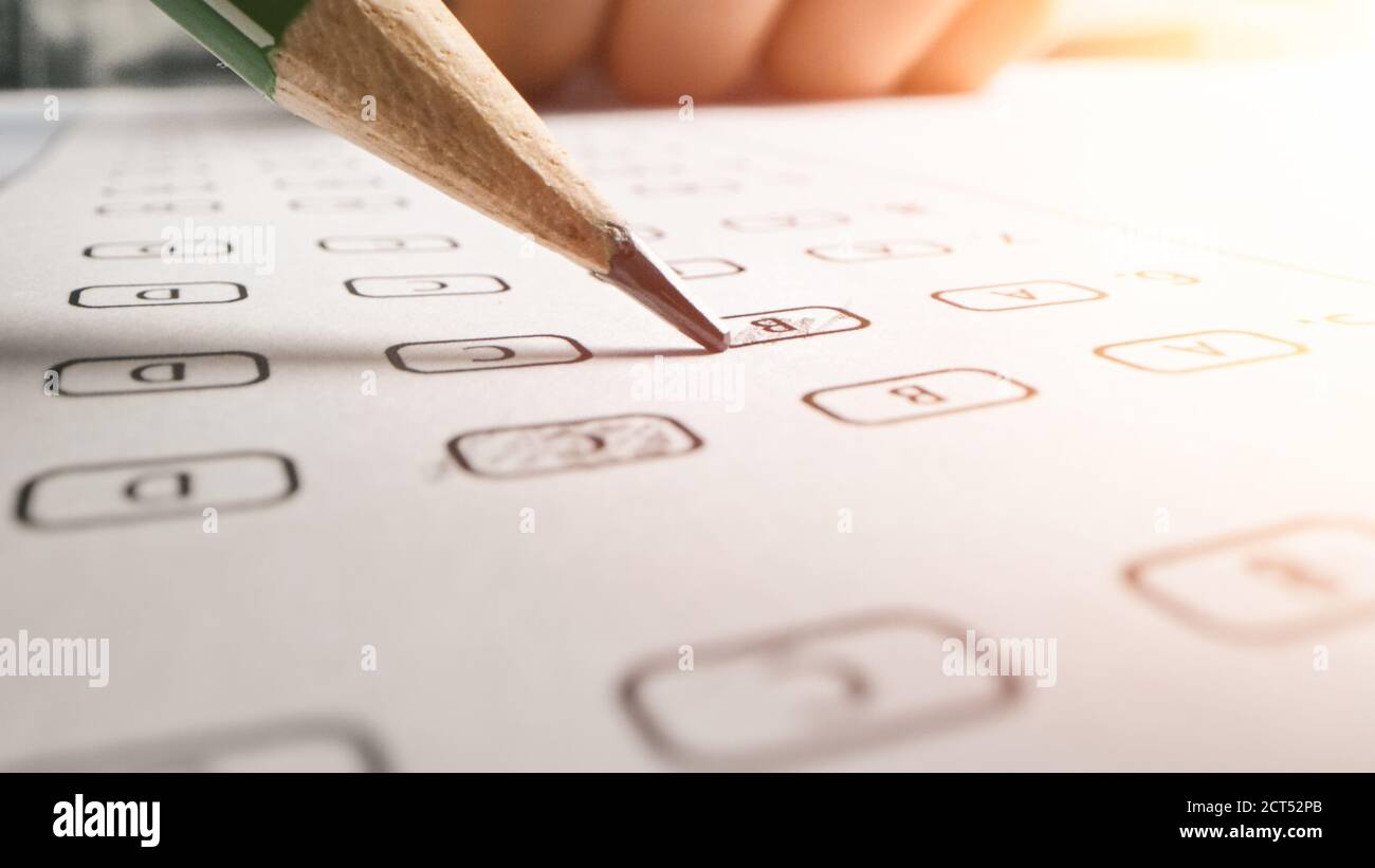 On Exam Test Person Colors Right Answers with a Pencil. Filling up ...