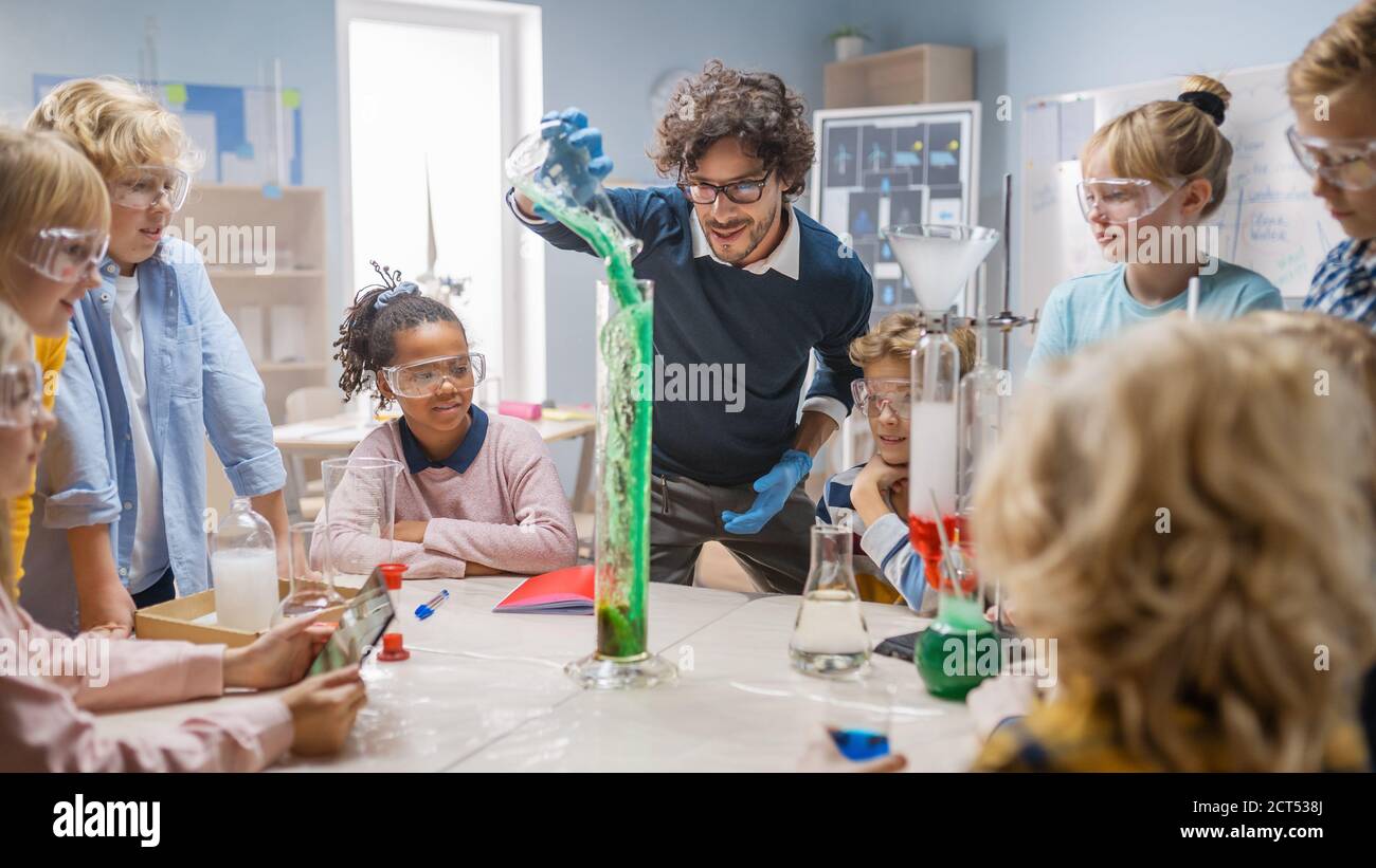Elementary School Science Chemistry Classroom: Teacher Shows Chemical ...