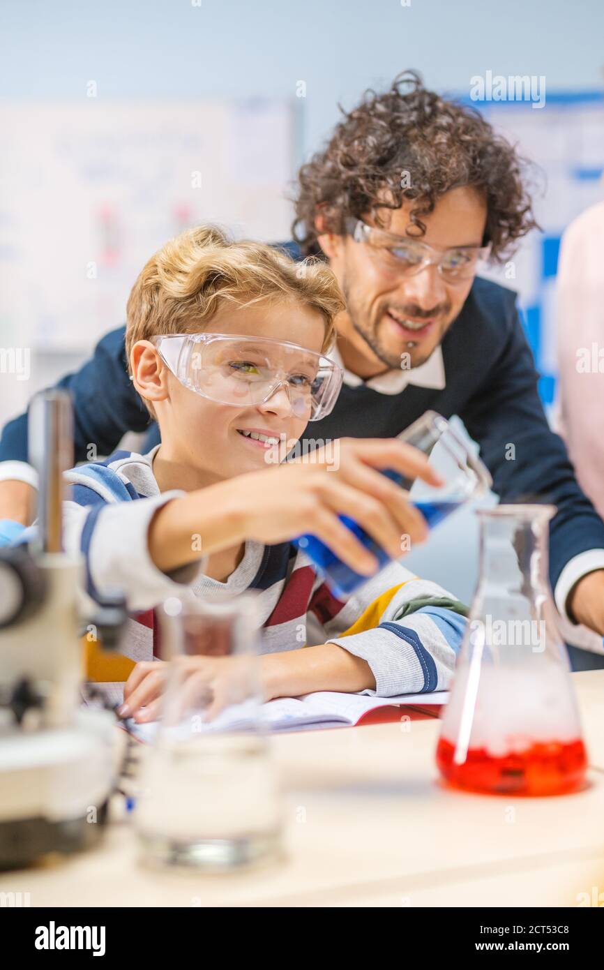 Elementary School Science Classroom: Little Boy Mixes Chemicals in ...