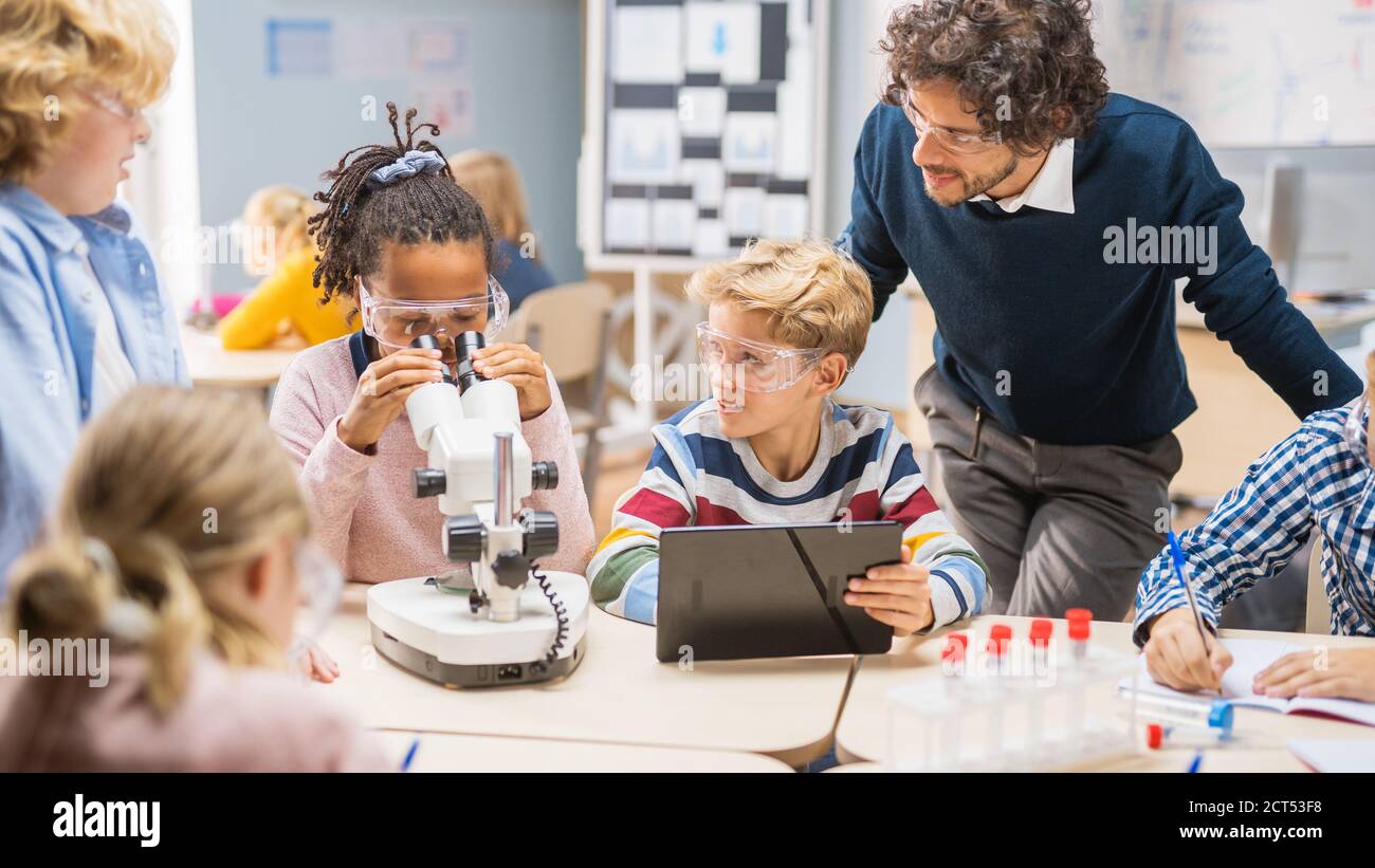Elementary School Science Classroom: Cute Little Girl Looks Under ...