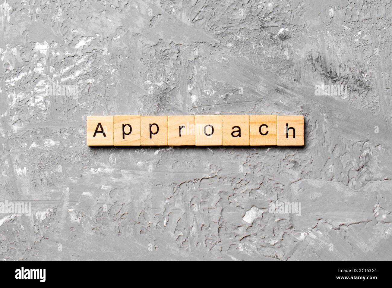 APPROACH word written on wood block. APPROACH text on cement table for ...