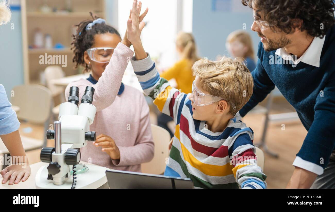 Elementary School Science Classroom: Cute Little Girl Looks Uses ...