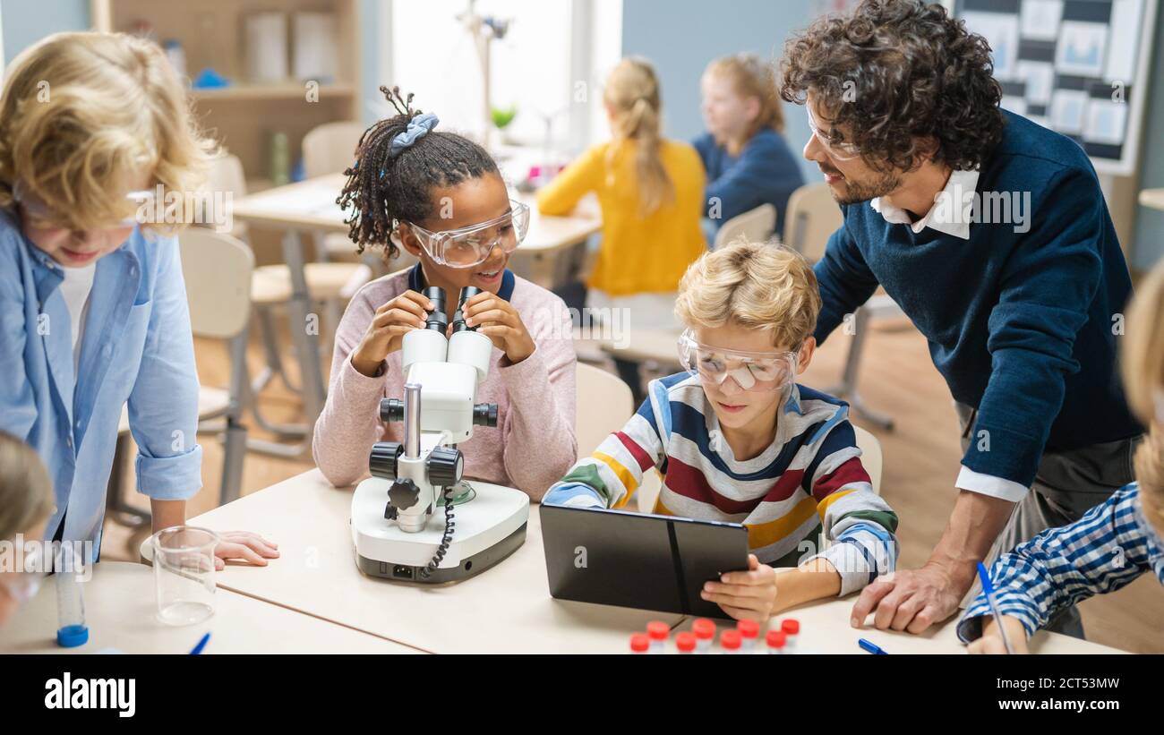 Elementary School Science Classroom: Cute Little Girl Looks Under ...
