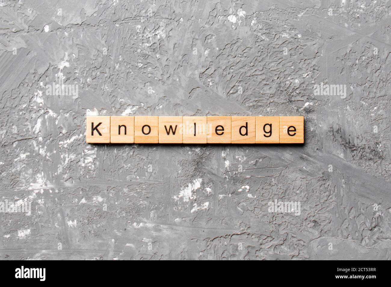 Knowledge word written on wood block. Knowledge text on cement table ...