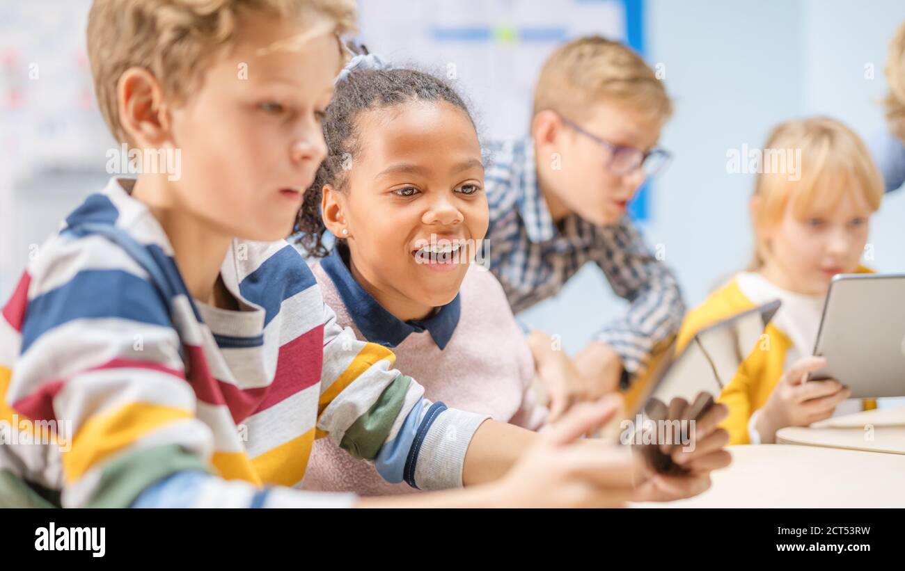 Elementary School Computer Science Class: Children Use Digital Tablet ... Elementary School Computer Science Class: Children Use Digital Tablet ...