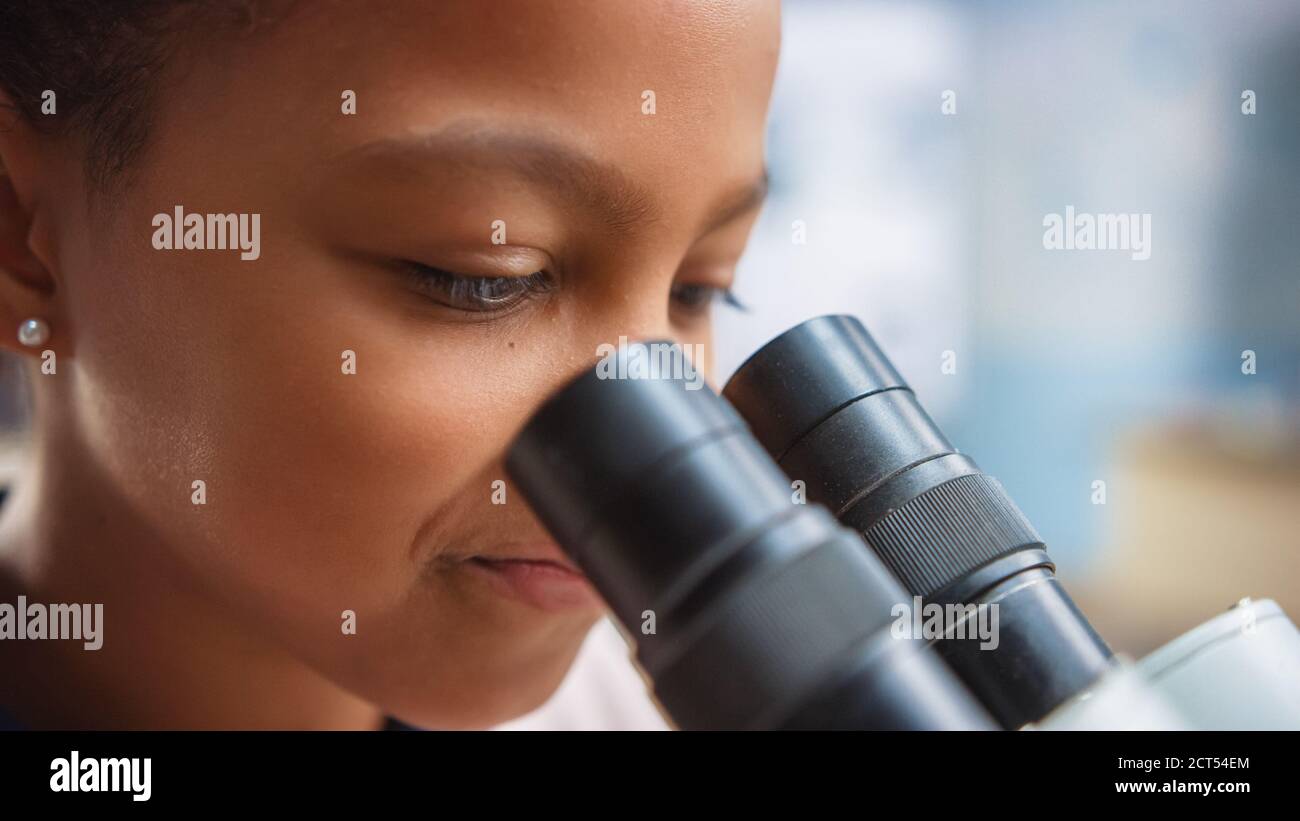 Portrait of Smart Little Schoolgirl Looking Under the Microscope. In ...