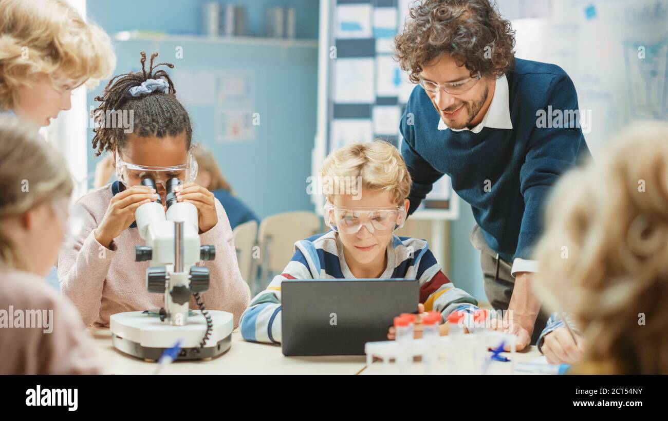 Elementary School Science Classroom: Cute Little Girl Looks Under ...