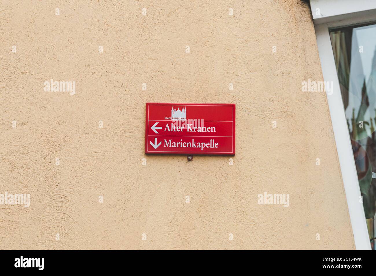 Red directional city tour sign for tourists on a street in Wurzburg ...