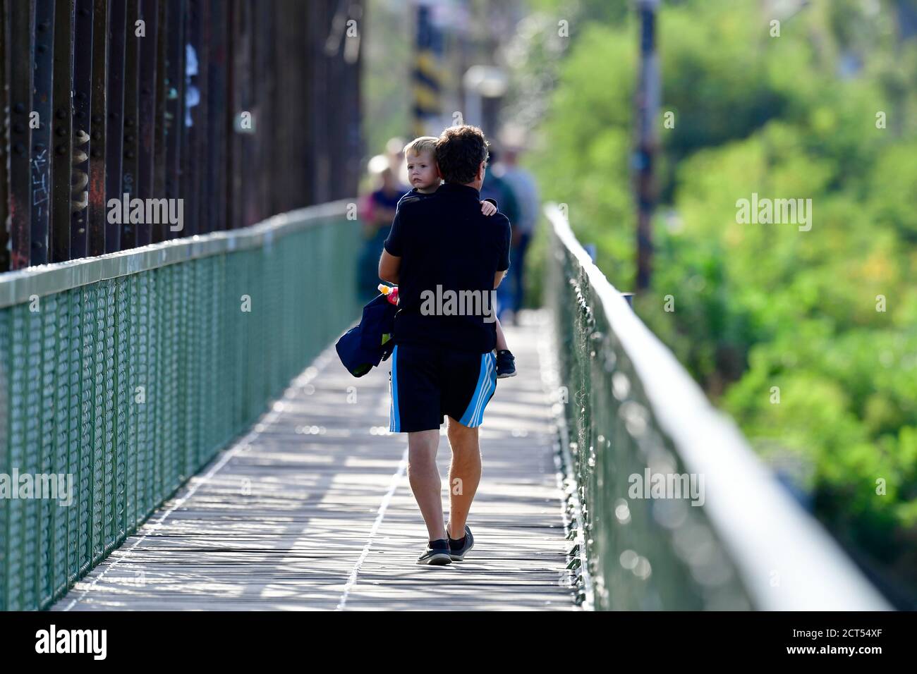 A man and boy walk across the bridge hi-res stock photography and ...