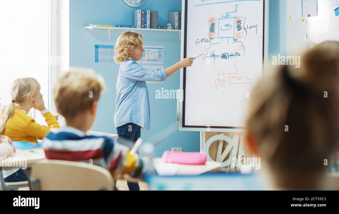 Elementary School Science Class: Cute Young Student Uses Interactive ...