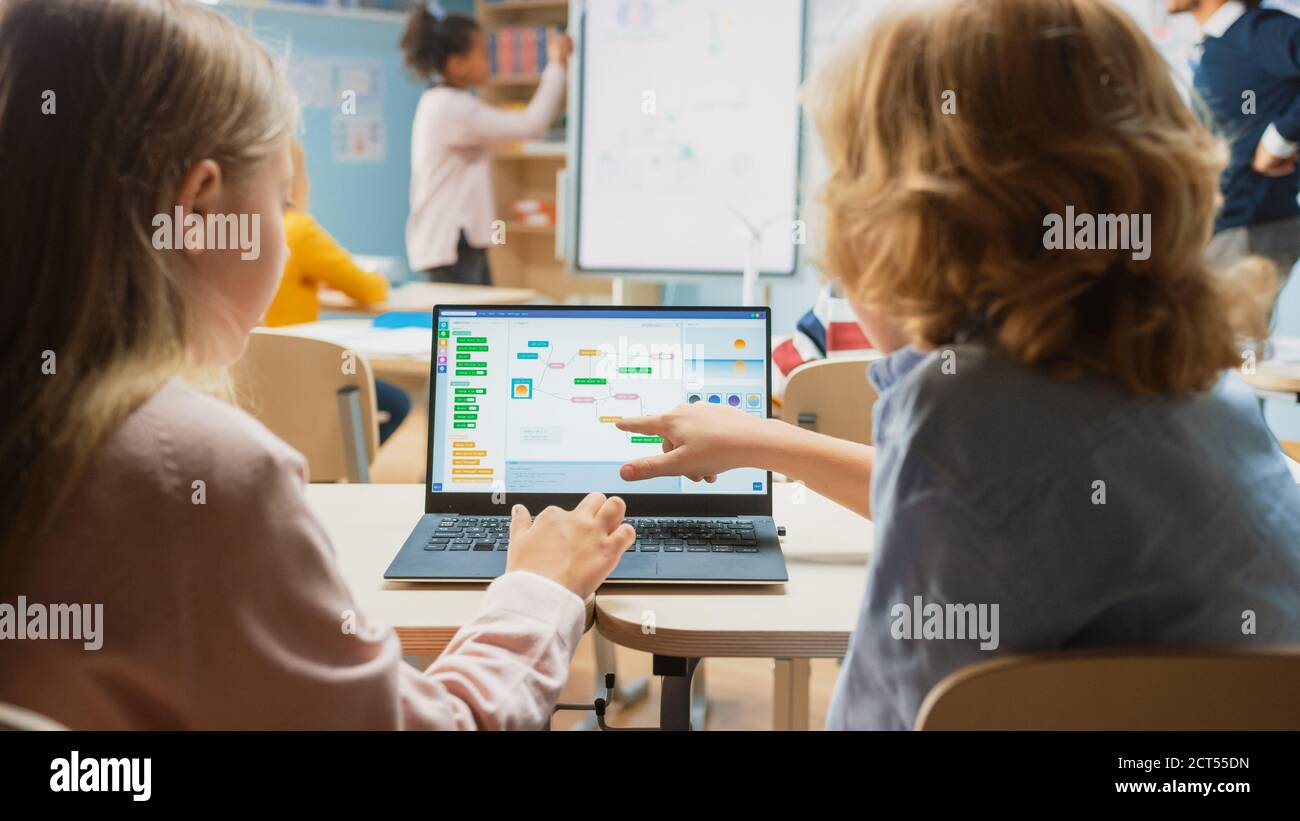 Elementary School Science Class: Over the Shoulder Little Boy and Girl ...
