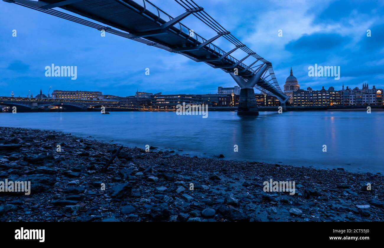 St Pauls Cathedral and Millennium Bridge at night seen at low tide from ...