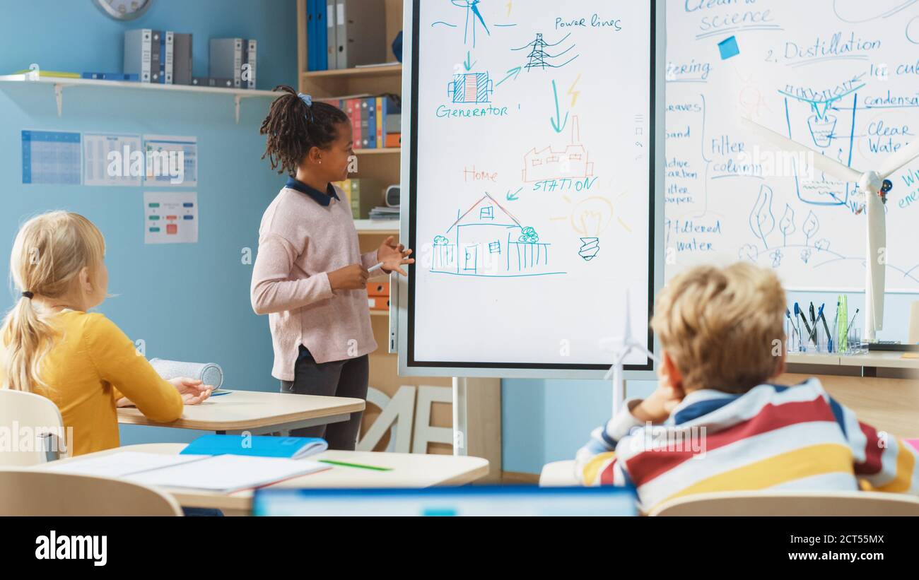 Elementary School Science Class: Cute Girl Uses Interactive Digital ...