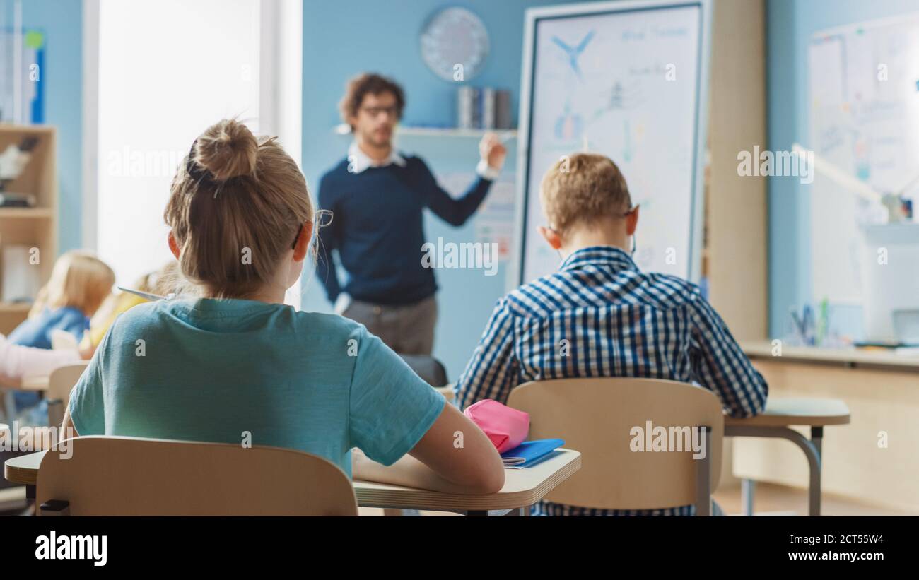 Back View Shot of a Brilliant Schoolgirl Carefully Listening to a ...