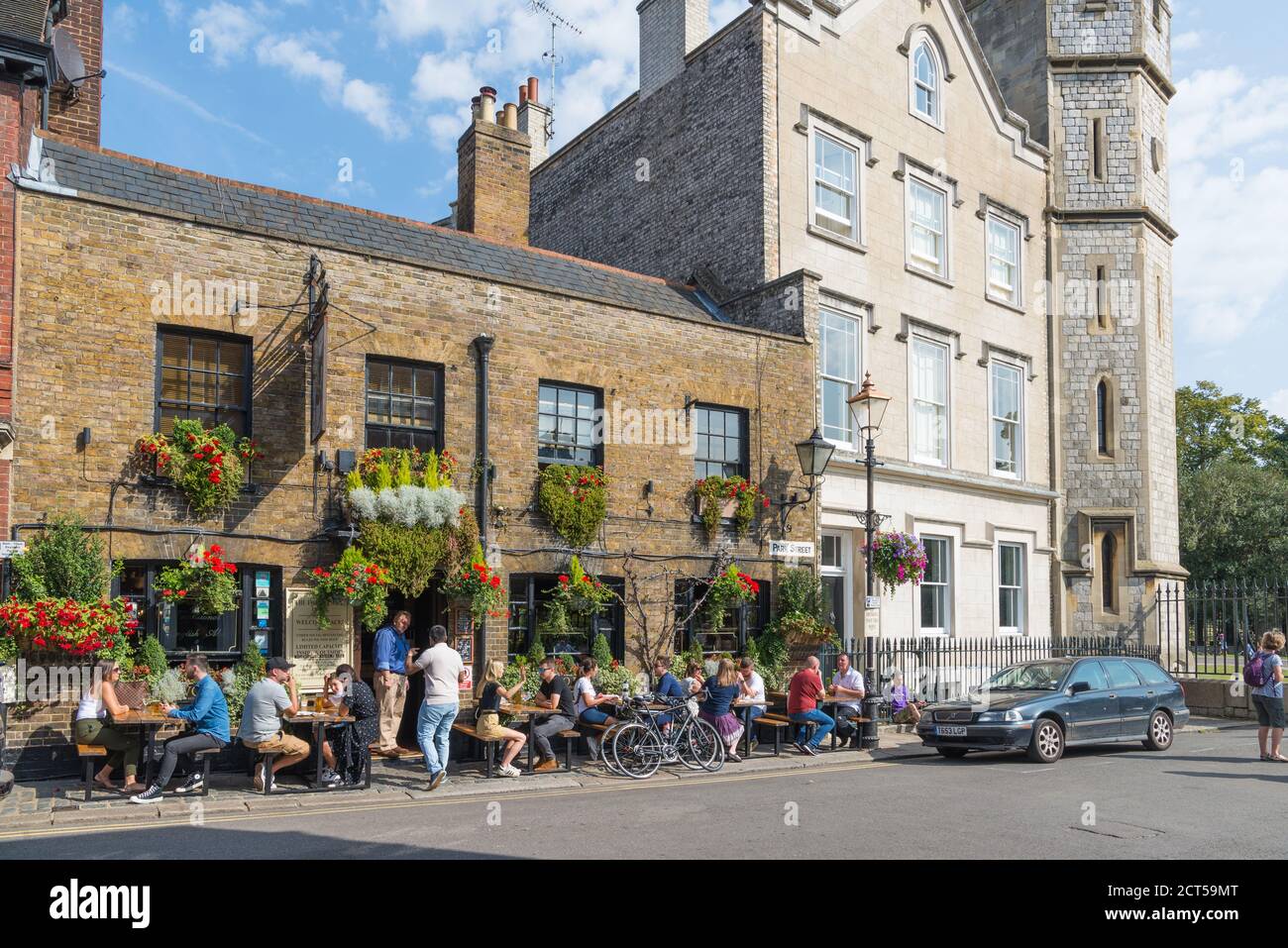 People enjoy a drink on a warm sunny day seated outside The Two Brewers ...