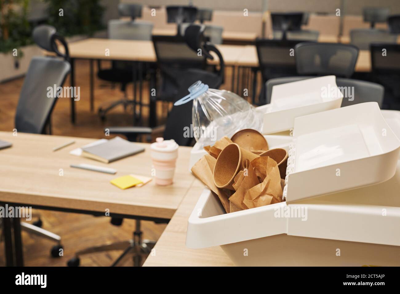 Background image of two waste sorting containers on desk in modern ...