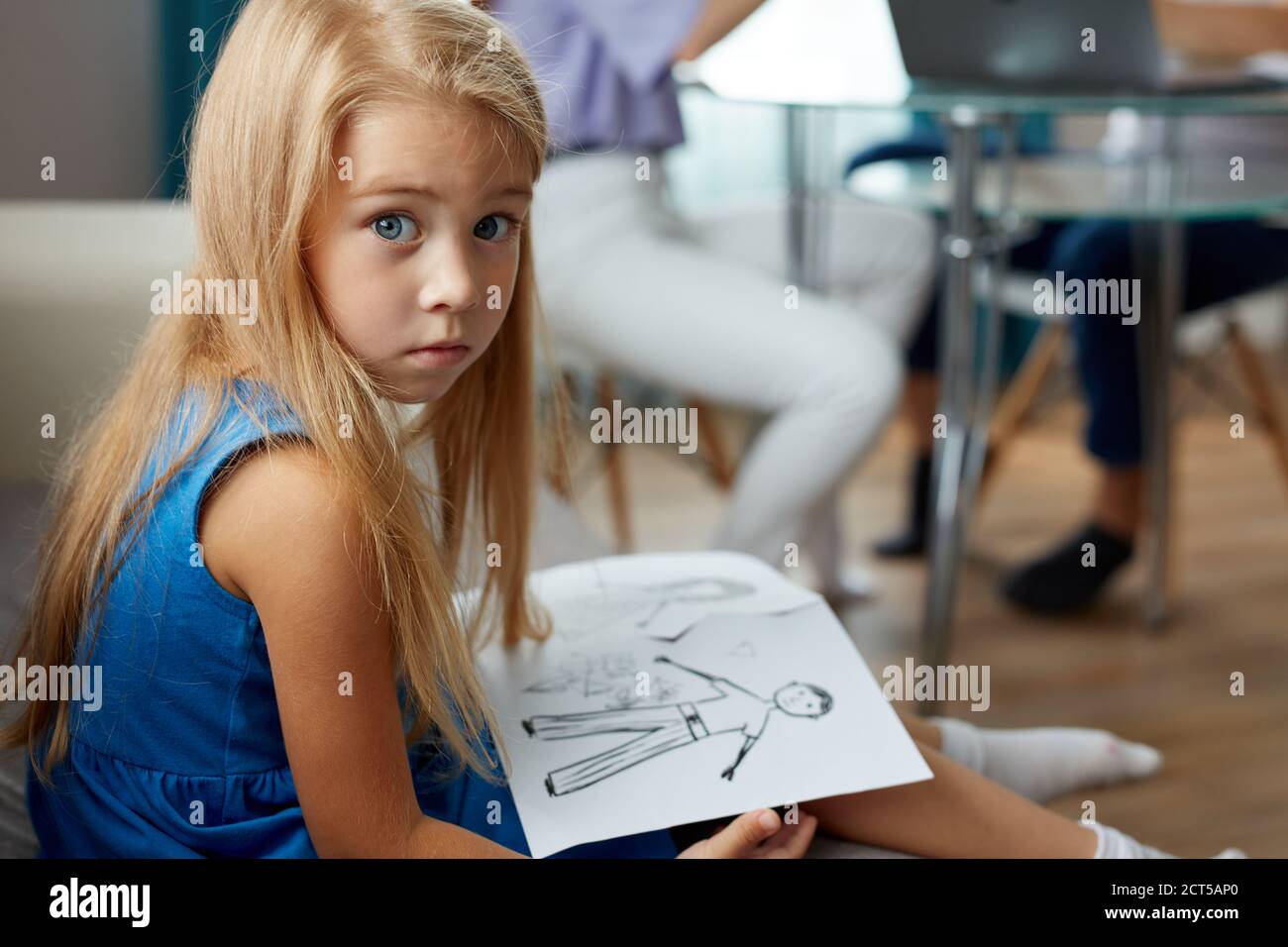 adorable caucasian child girl hold drawing of parents separated, they ...