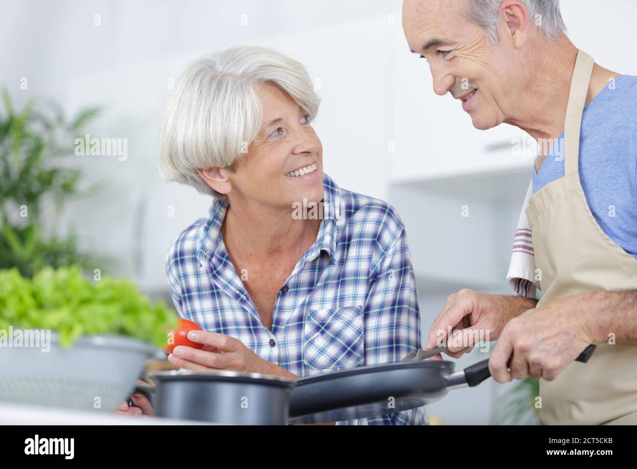 a mature couple cooking together Stock Photo - Alamy