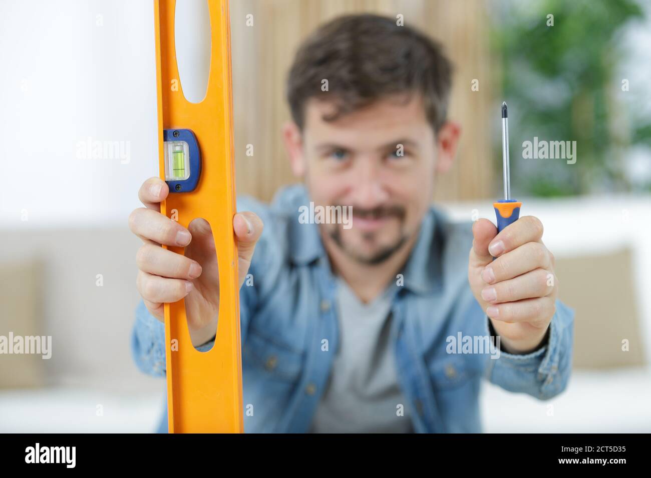 man showing tools while doing diy Stock Photo - Alamy