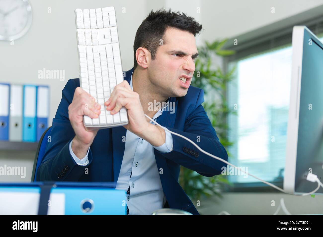 angry man is destroying a keyboard Stock Photo - Alamy