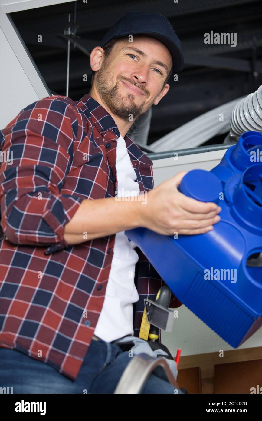 man replacing the air filter on the ceiling Stock Photo - Alamy