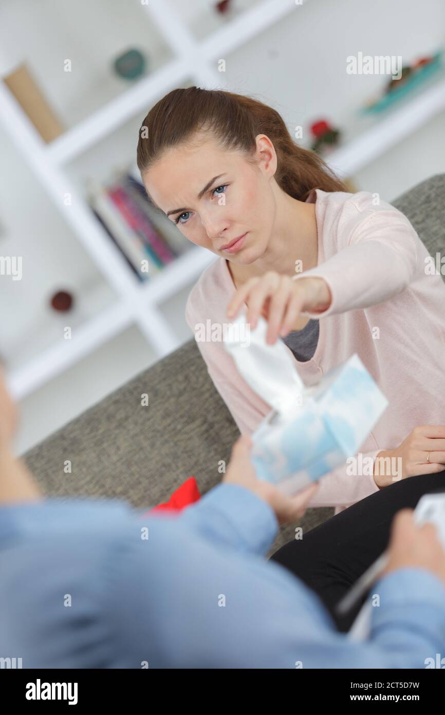 therapist giving tissue to a woman because she is crying Stock Photo ...