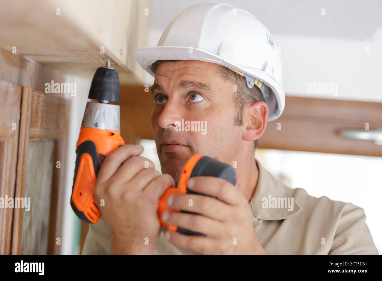 man builder using a drill Stock Photo - Alamy