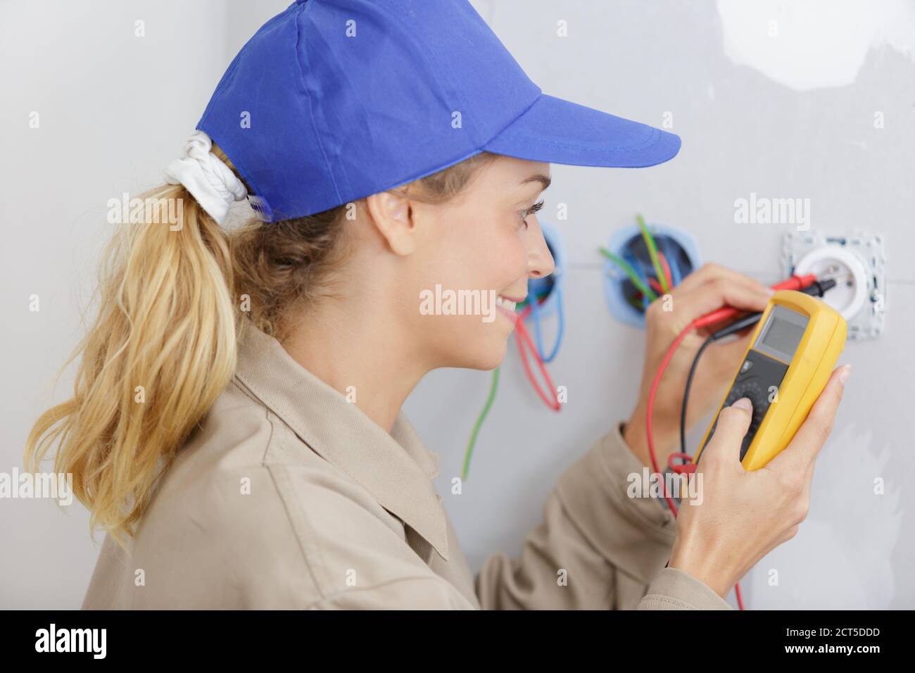 portrait of a woman measuring electrical current Stock Photo - Alamy
