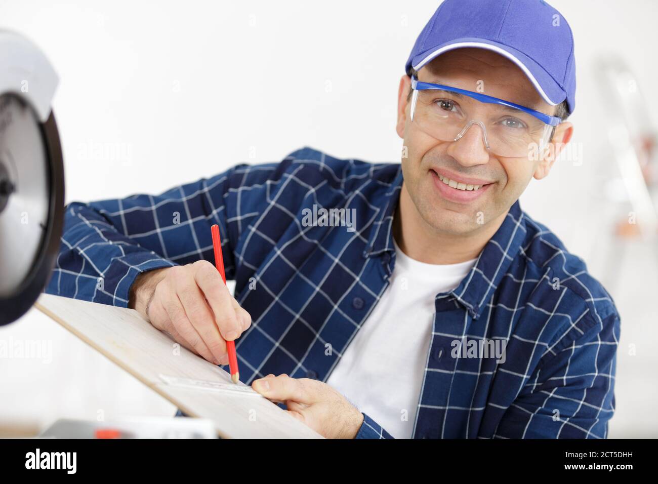 craftsman measuring with ruler and pencil on a wood board Stock Photo ...